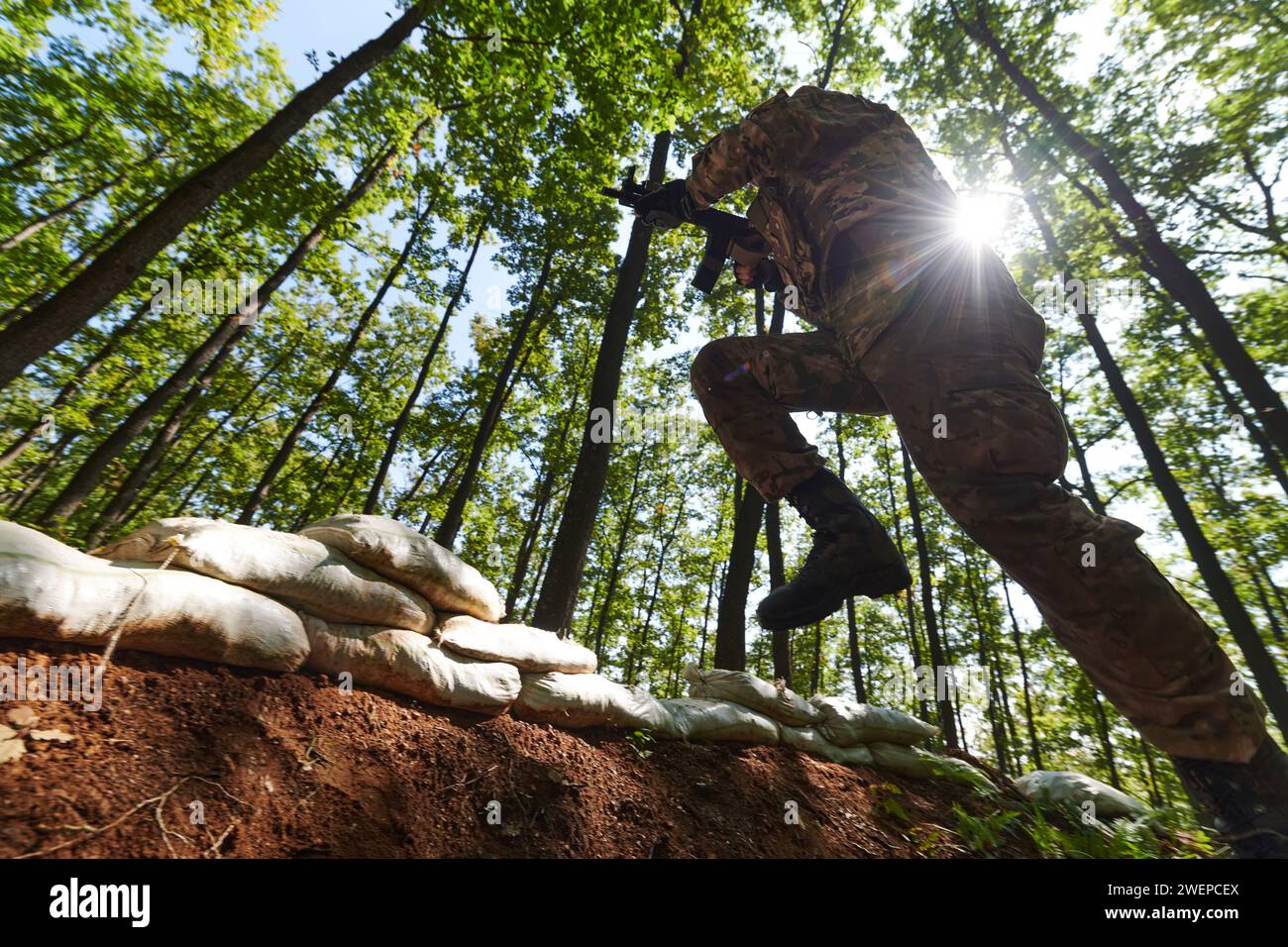 An elite soldier adeptly clears military barriers in the perilous ...