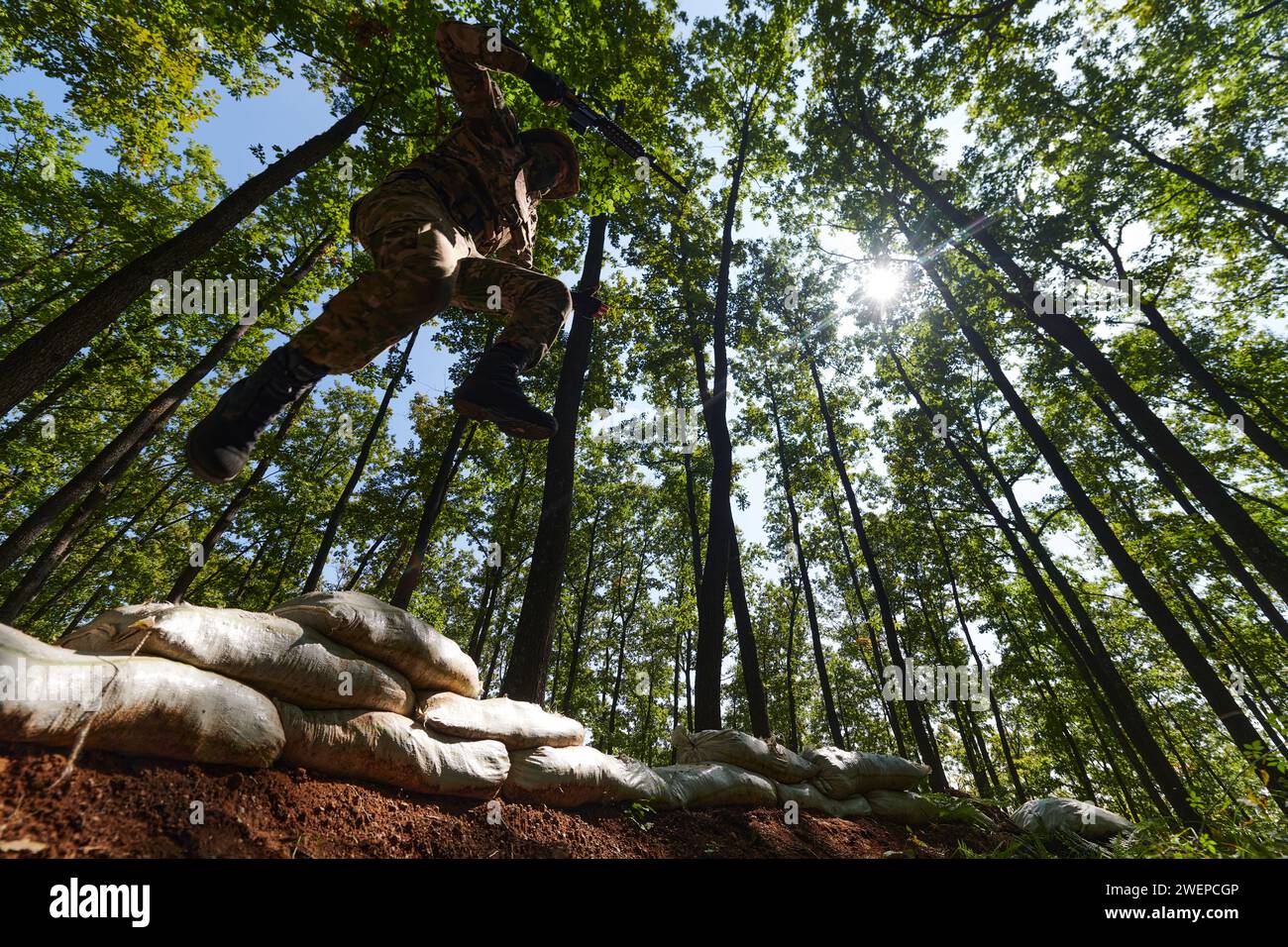 An elite soldier adeptly clears military barriers in the perilous ...