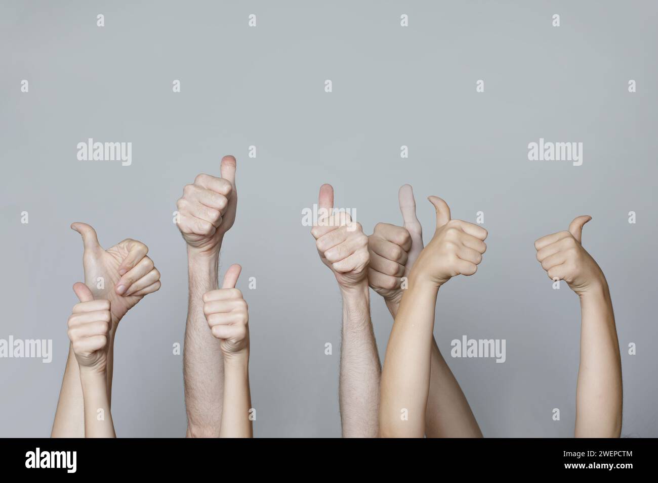Many people congratulate a winner and holding their thumbs up. Human ...
