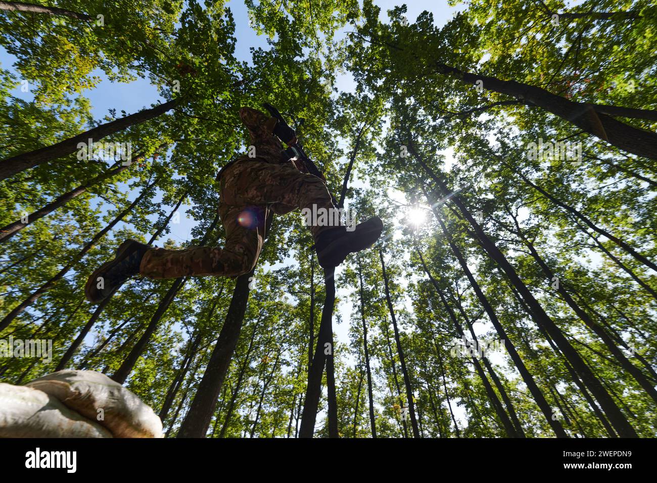 An elite soldier adeptly clears military barriers in the perilous ...