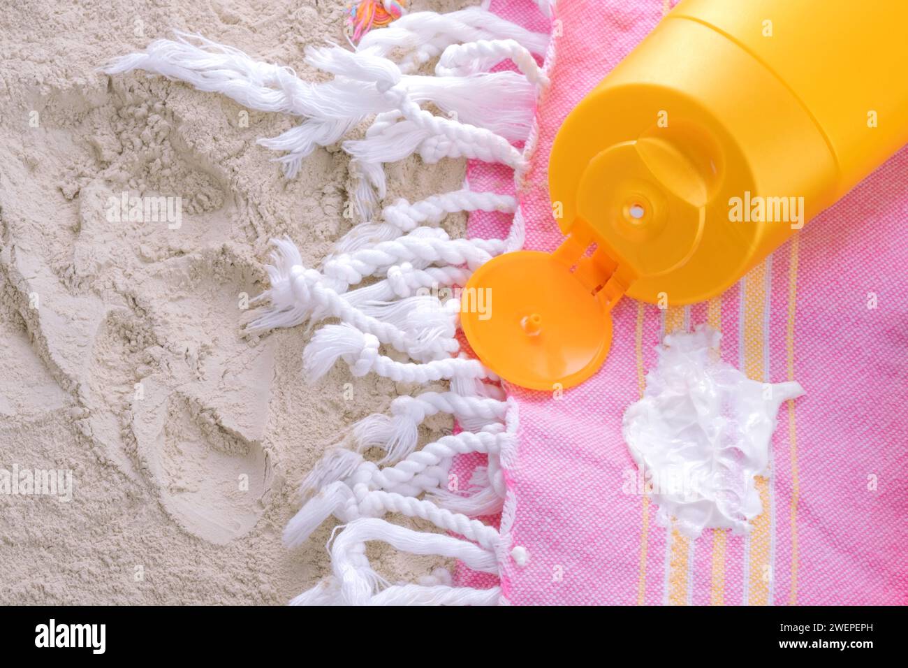 Dirty stain of spilled cream on clothes on the beach. White skin care ...