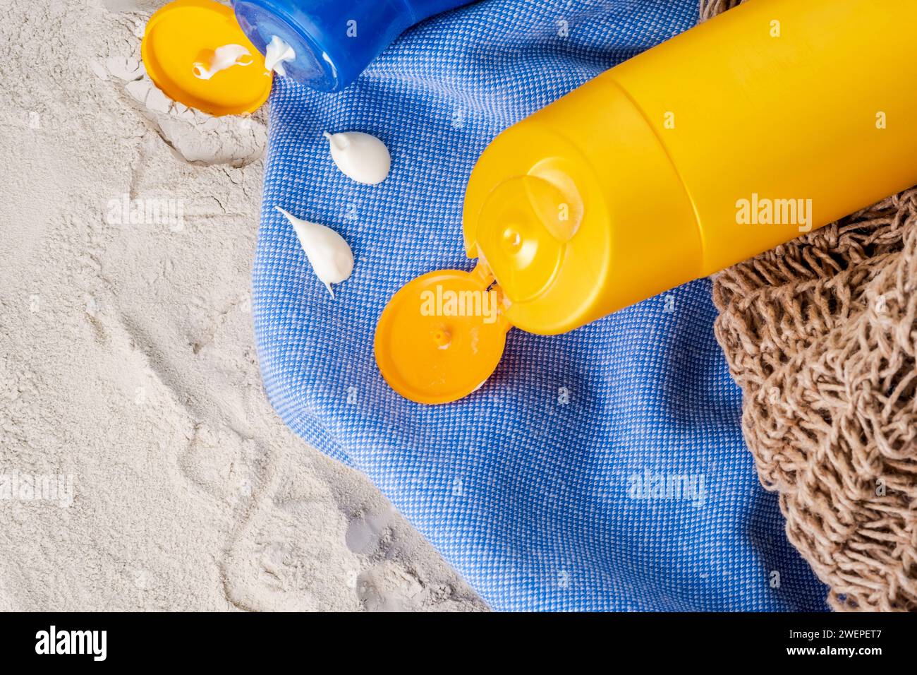 Dirty stain of spilled cream on clothes on the beach. White skin care ...