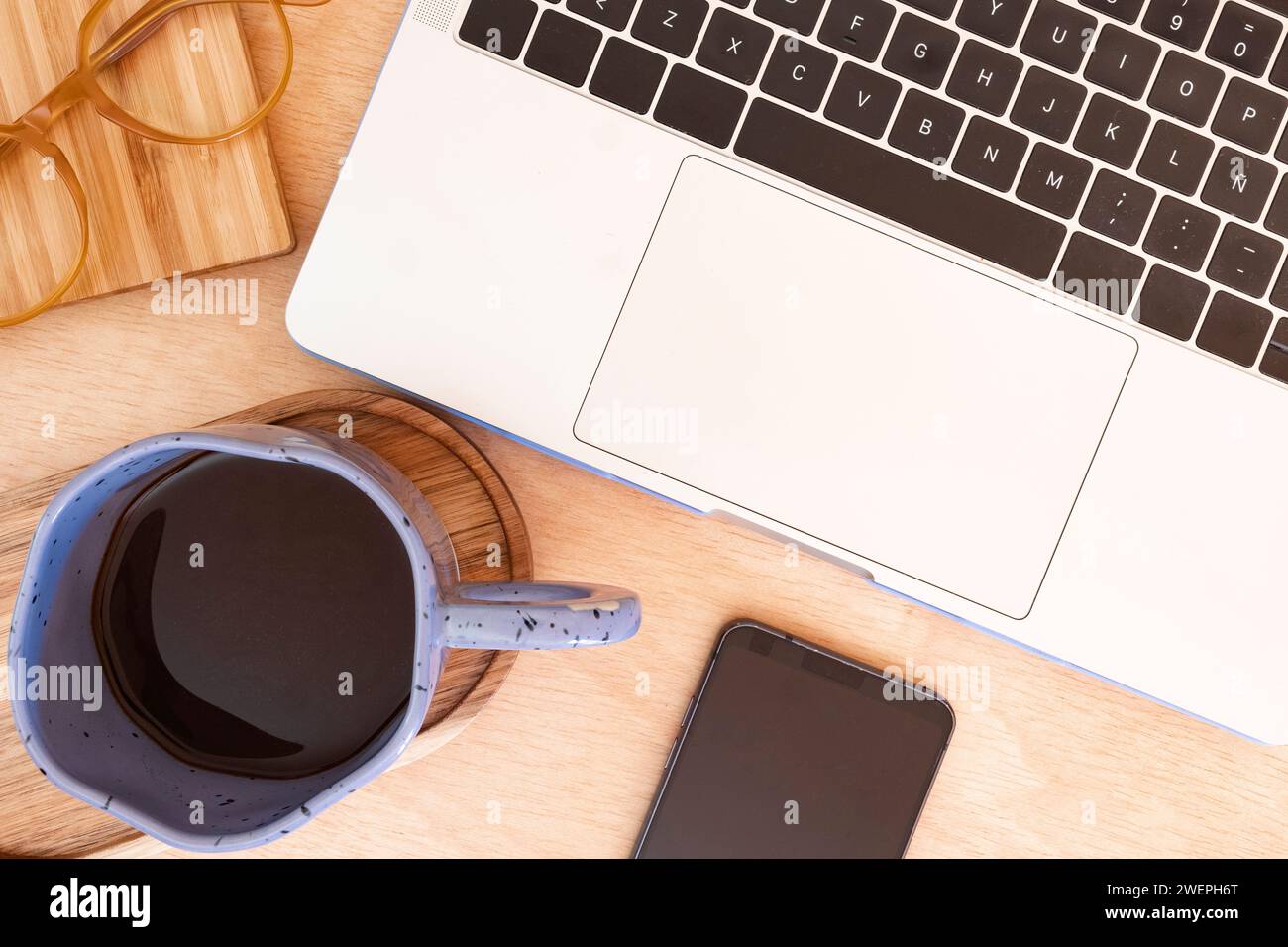 Mug placed beside computer on desk Stock Photo - Alamy