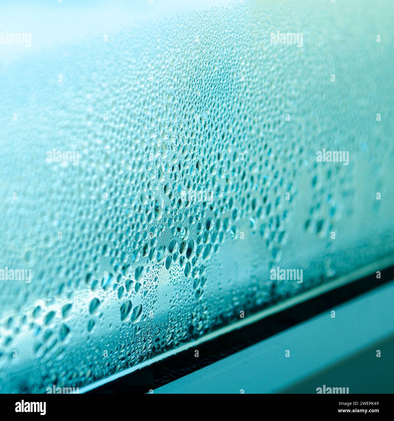 Greenhouse effect. Drops of condensation on the glass of a metal ...