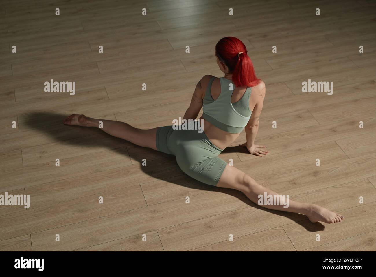 Flexible Woman Sitting in Front Split Stock Photo - Alamy
