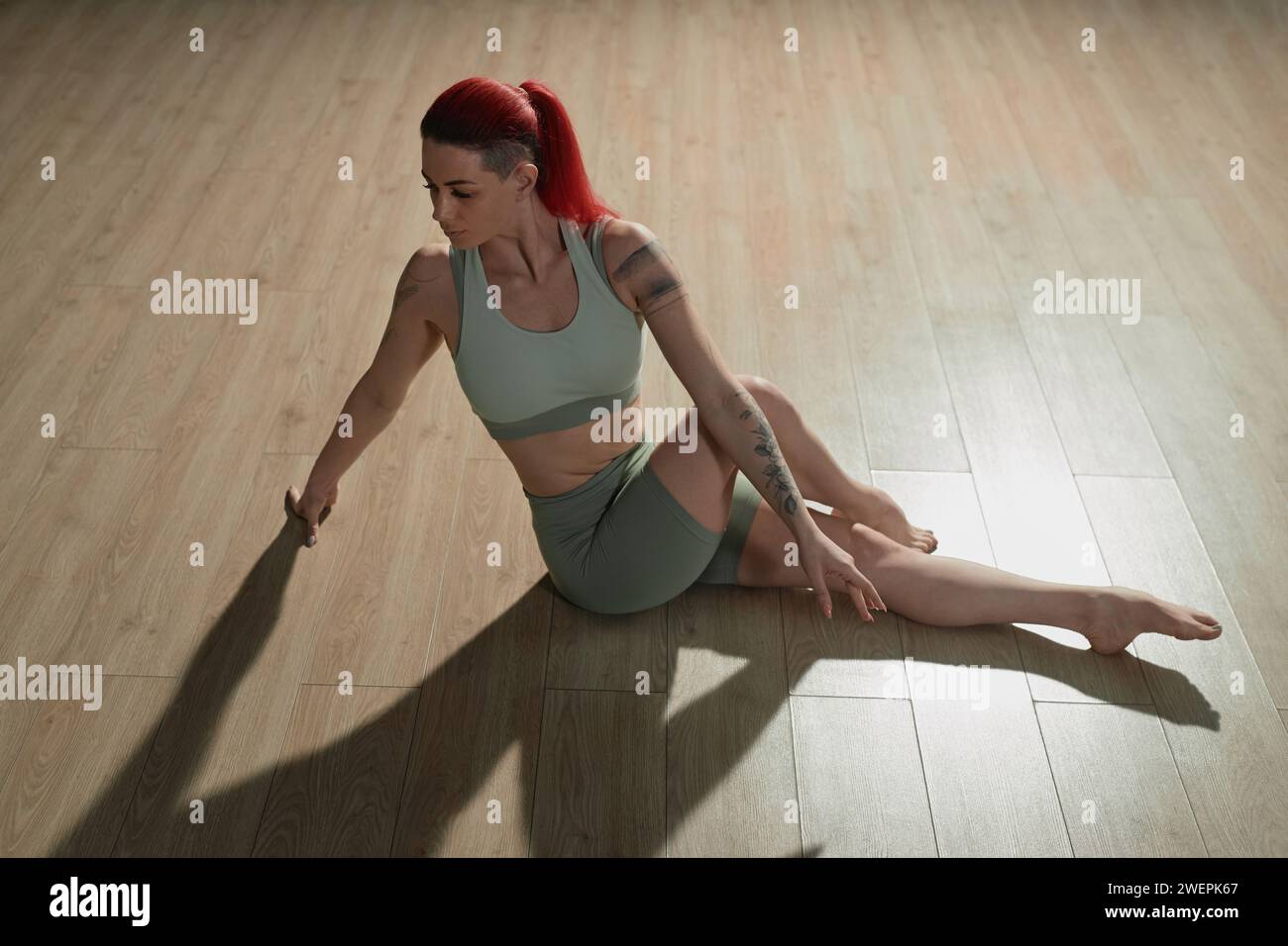 Young Female Dancer Doing Seated Hip Stretch Stock Photo - Alamy