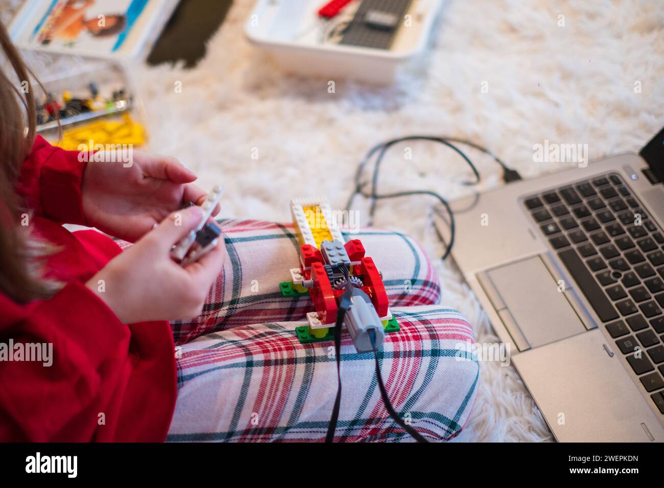 Tallinn, Estonia - December 25, 2023: Child building a moving Lego ...