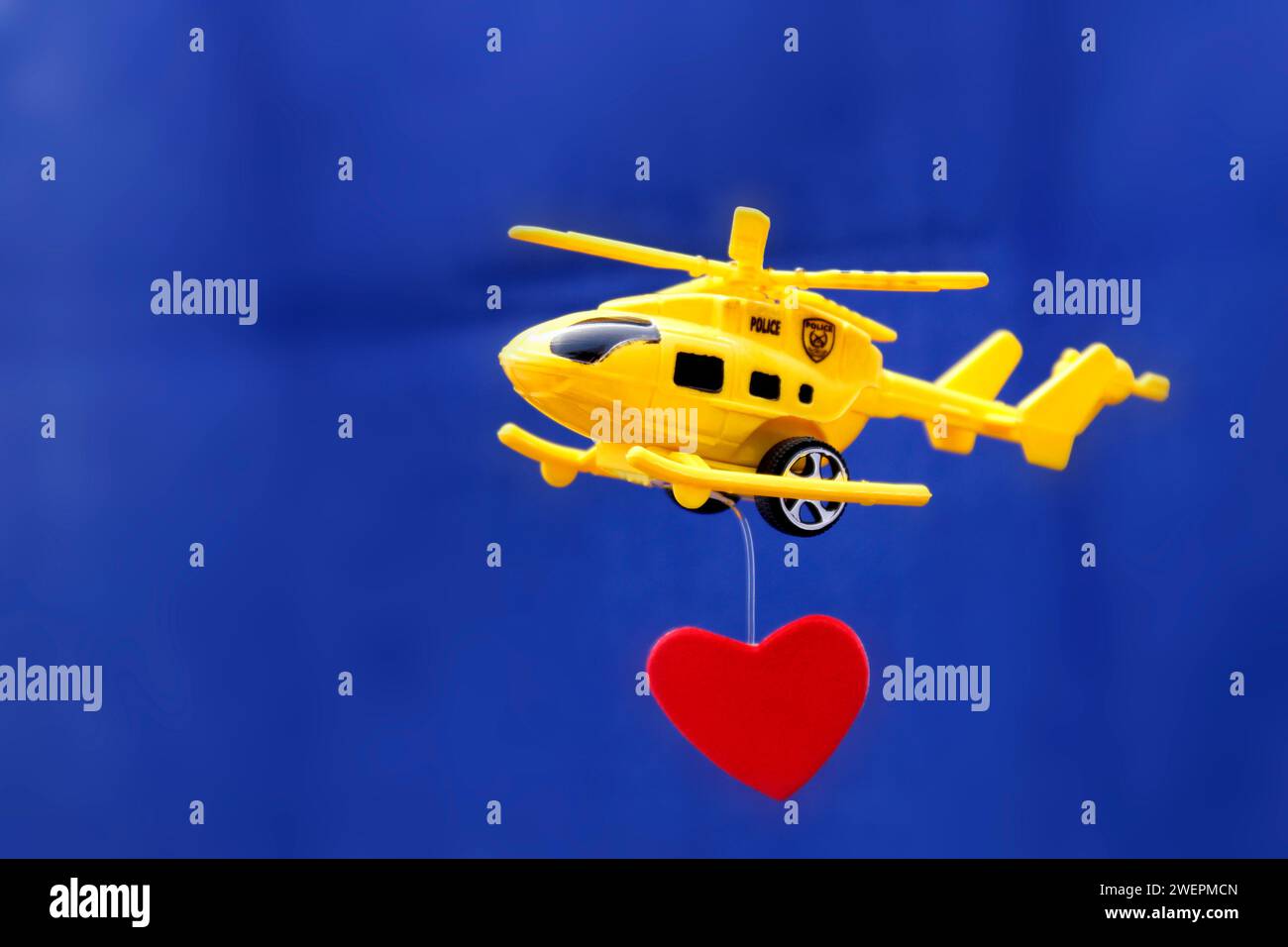 Police helicopter carrying a big heart Stock Photo - Alamy