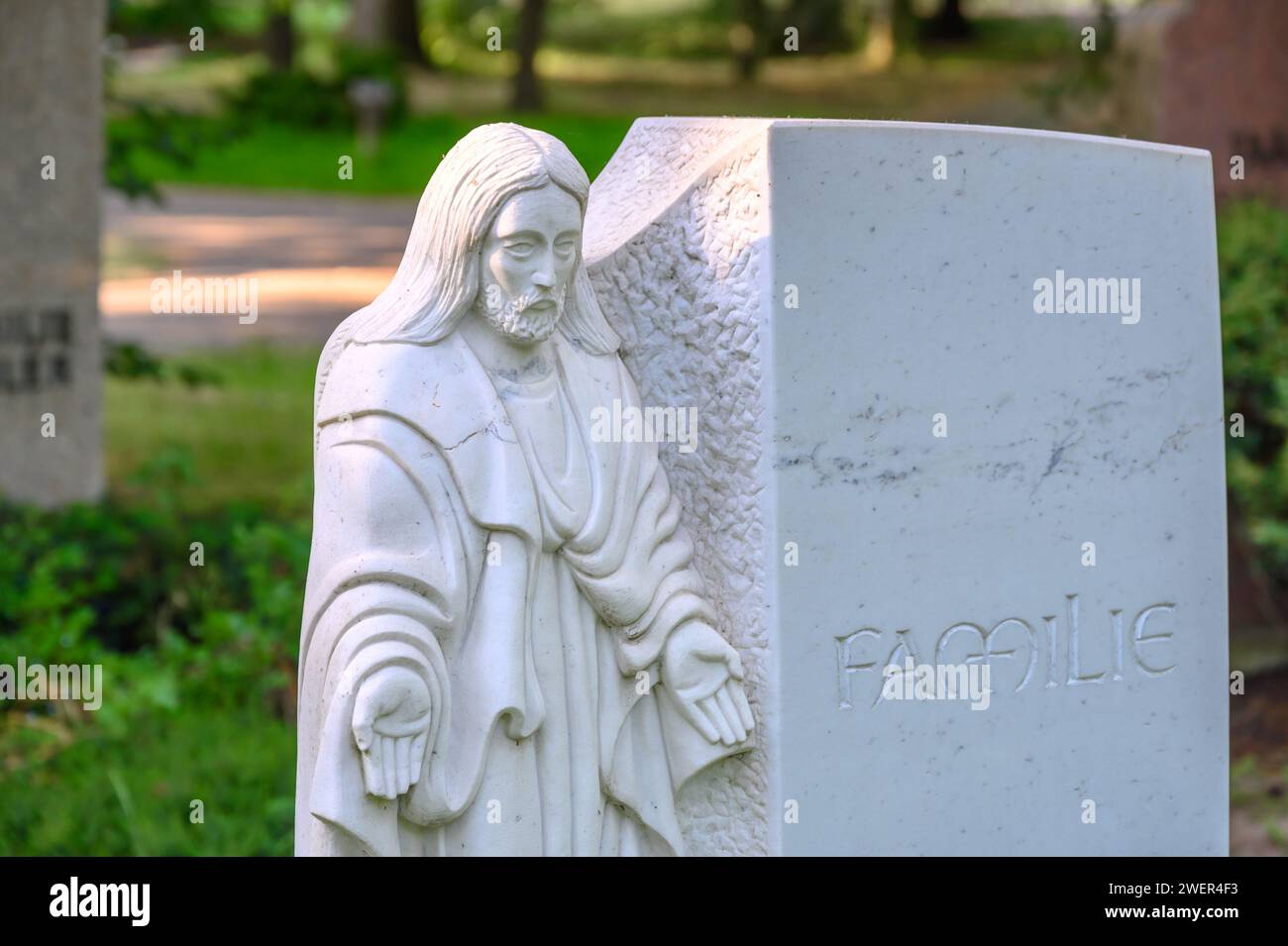 White figure of Jesus with stigmata in his hands on the gravestone of ...