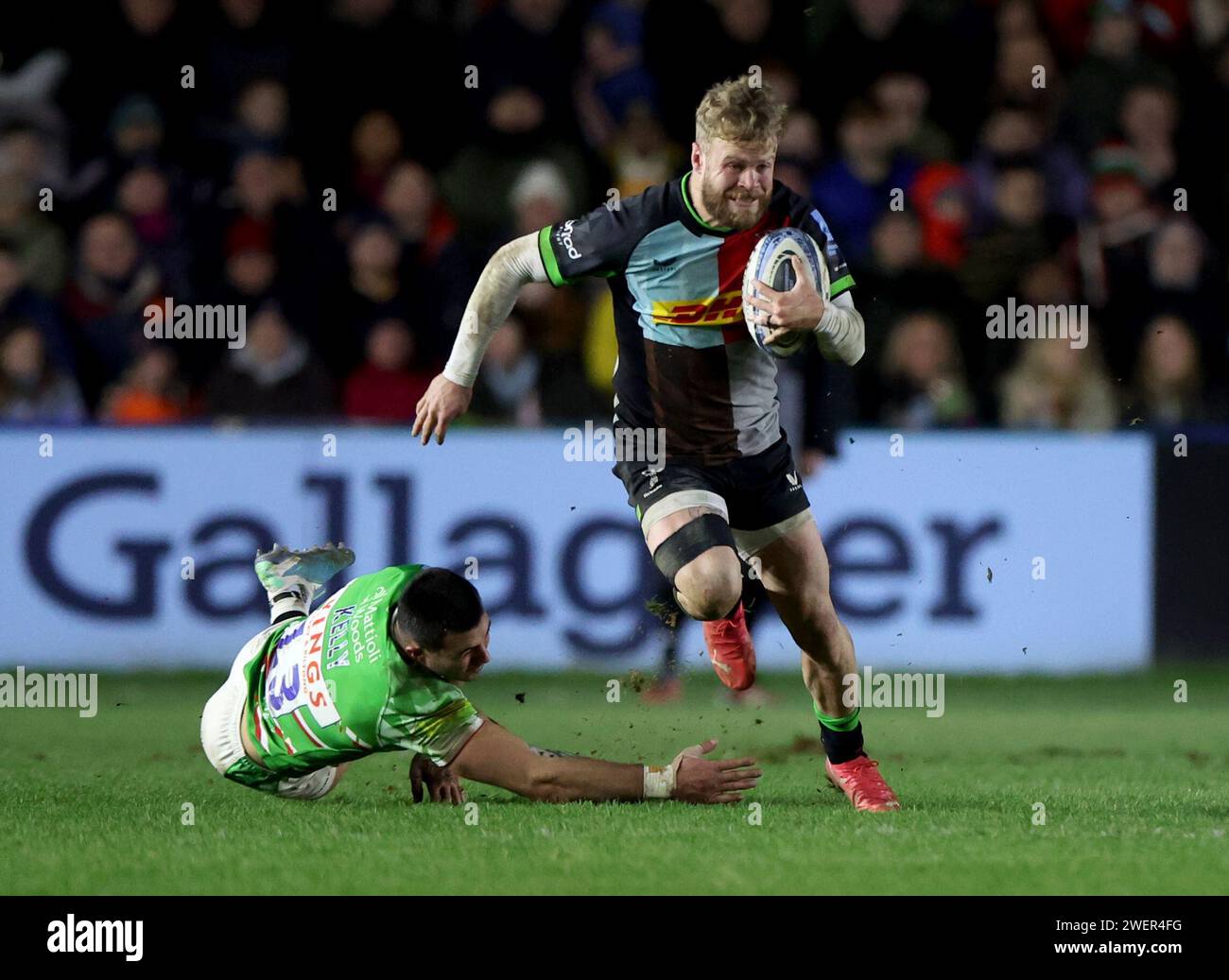 Harlequins' Tyrone Green (right) skips past a tackle from Leicester ...