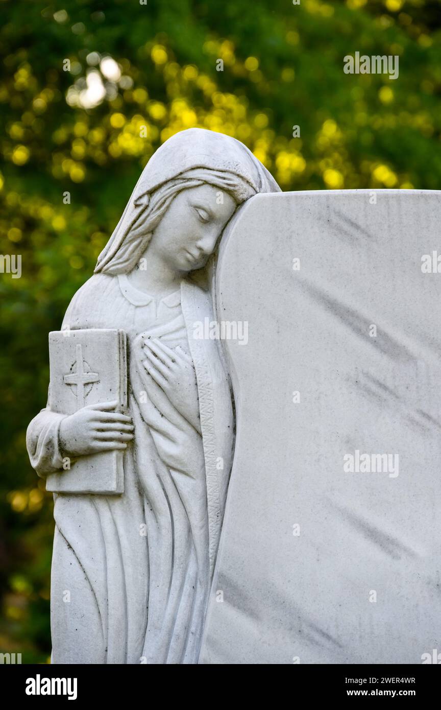 Statue of woman with book on gravestone with text space Stock Photo - Alamy