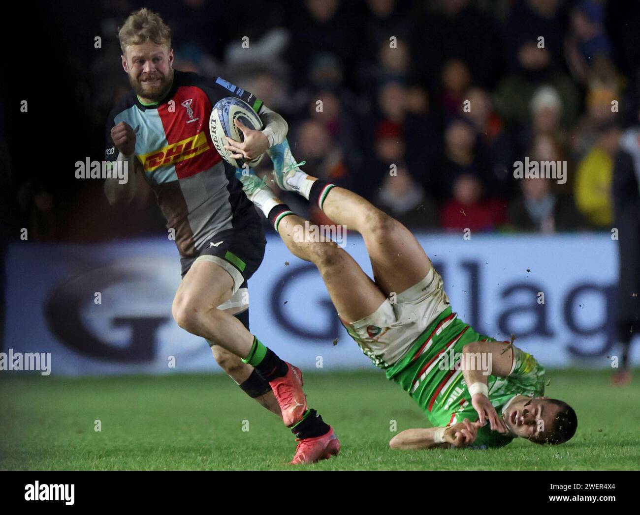 Harlequins' Tyrone Green (left) skips past a tackle from Leicester ...