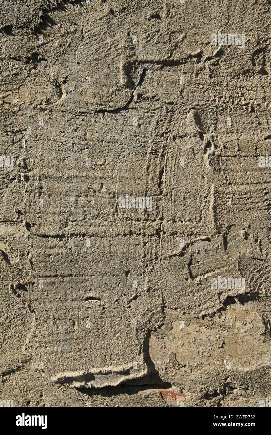 Old, sloppy, multi-layered wall covering of the house. Rough, uneven ...