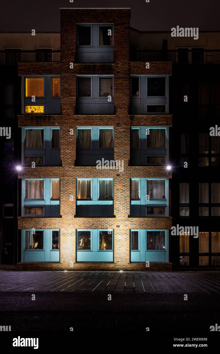 A vertical shot of a nighttime cityscape showcasing vintage brick ...