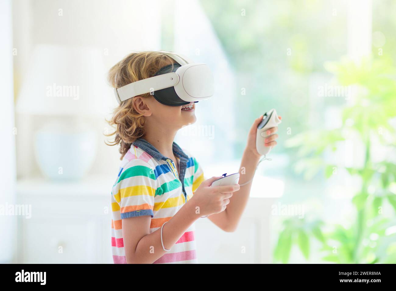 Child in virtual reality goggles. VR set for kids. Little boy playing ...