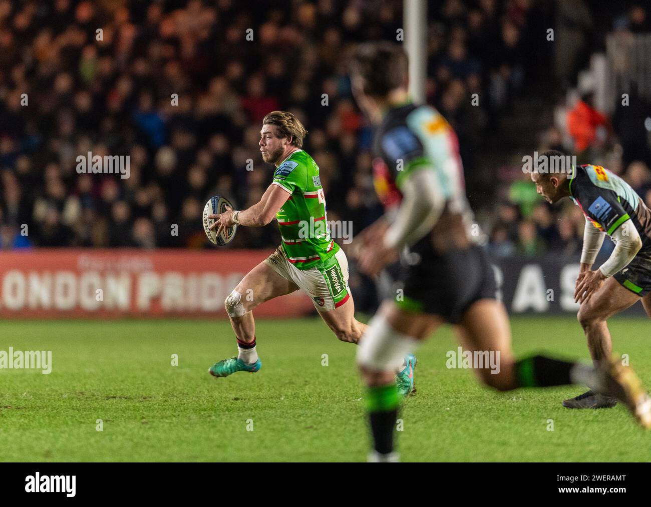 Ollie Hassell- Collins of Leicester Tigers runs with the ball during ...