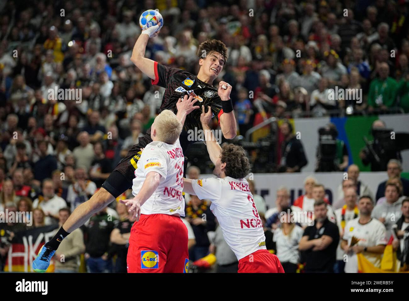Germany's Julian Koester, top, attempts a score during the Handball ...