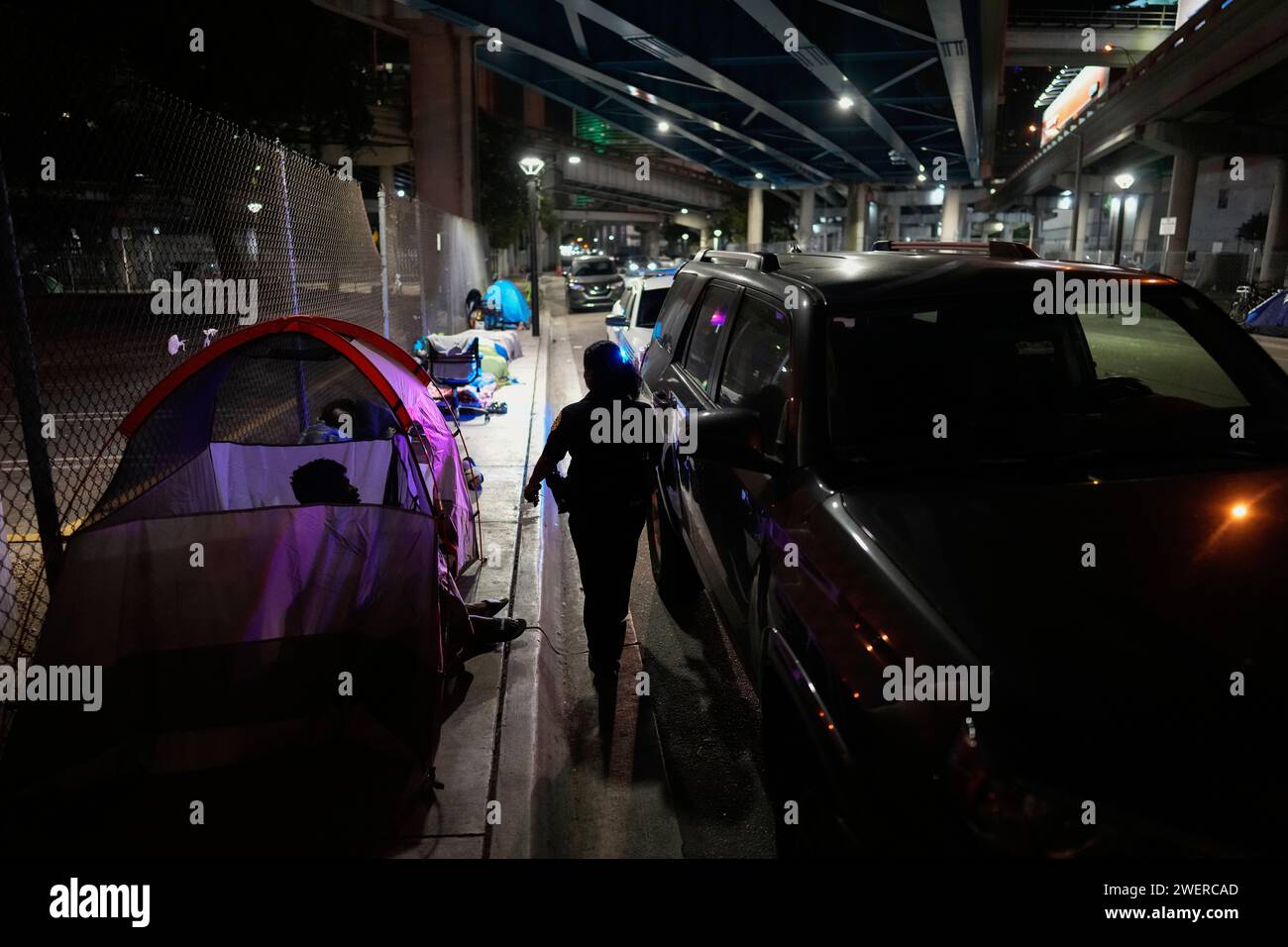 City of Miami Police Officer Shareka Lewis, center, greets unsheltered ...