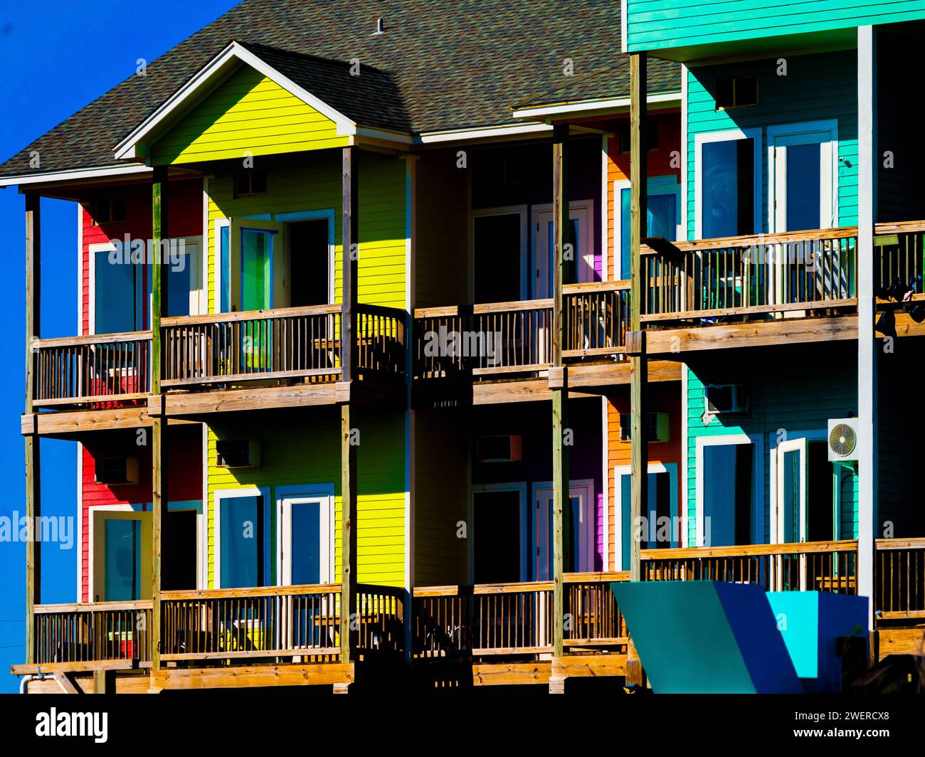 Some colorful buildings and chairs on a beach under a blue sky Stock ...
