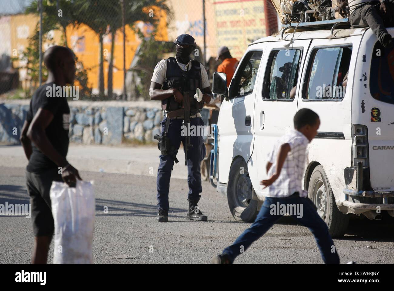 A police officer inspects a public transportation vehicle at a ...