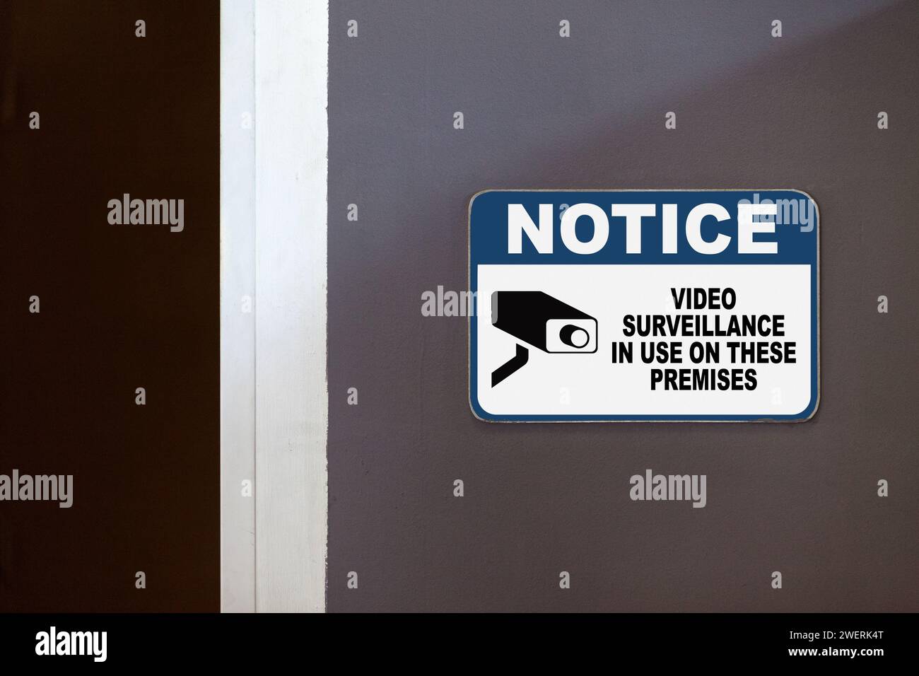 Blue and white notice sign on the side of an open door stating "Notice ...