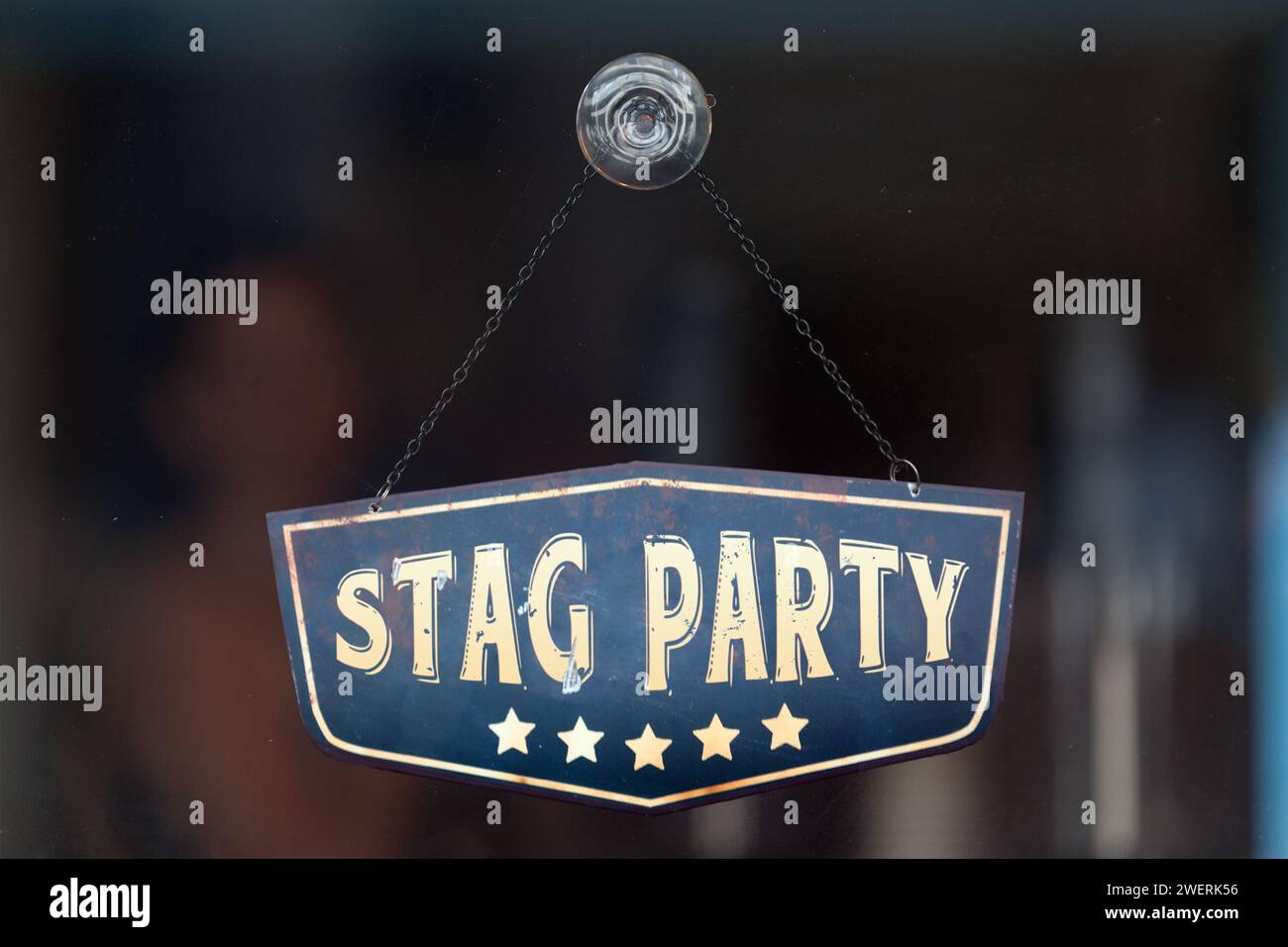 Old fashioned sign in the window of a shop saying in "Stag Party Stock ...