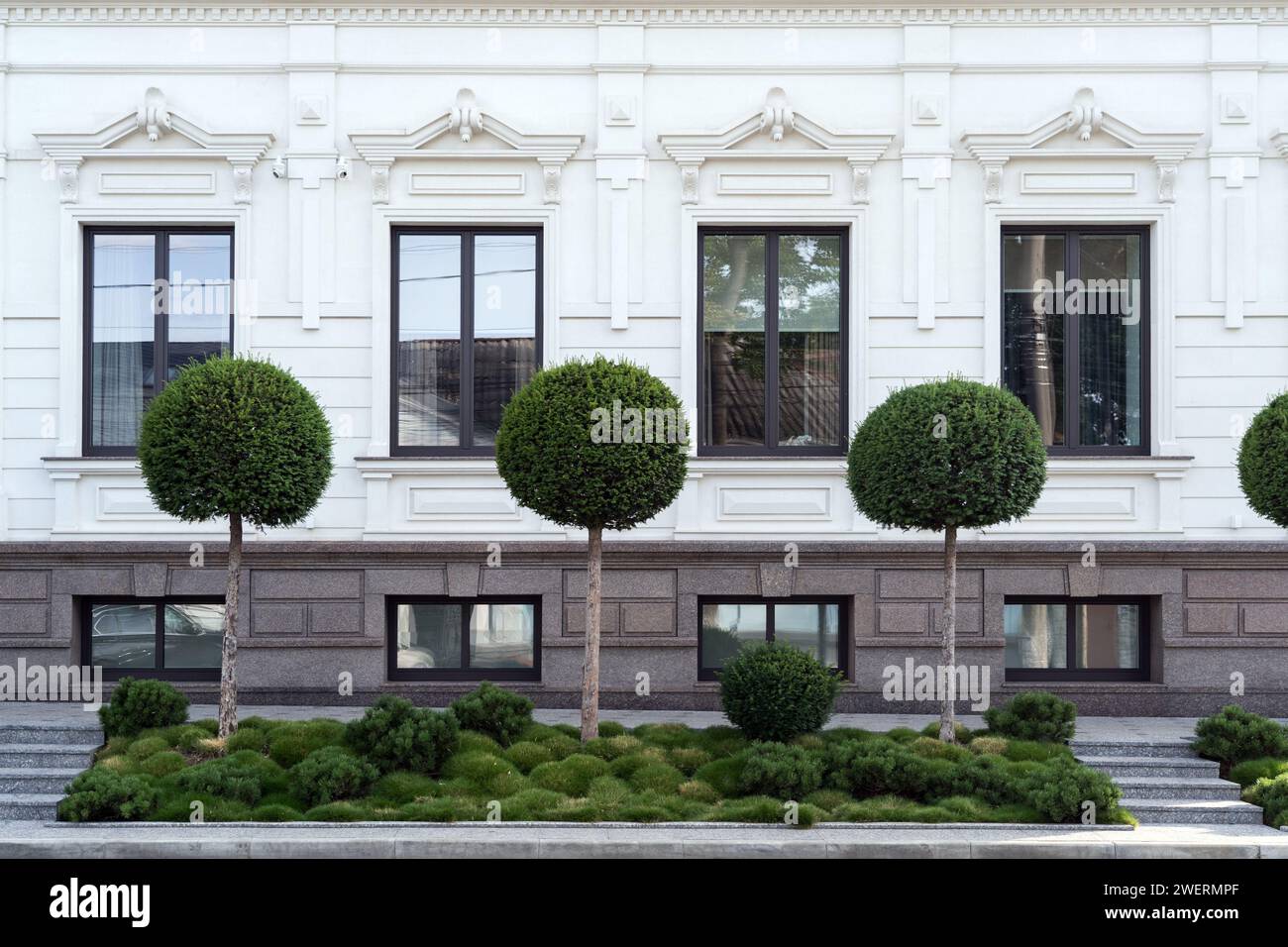 Elegant Building Facade with Ornamental Trees Stock Photo - Alamy