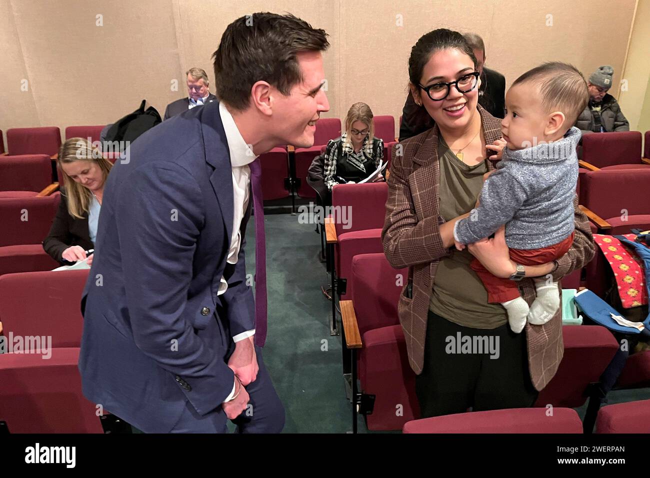 Nebraska state Sen John Fredrickson greets Anahi Salazar and her son ...