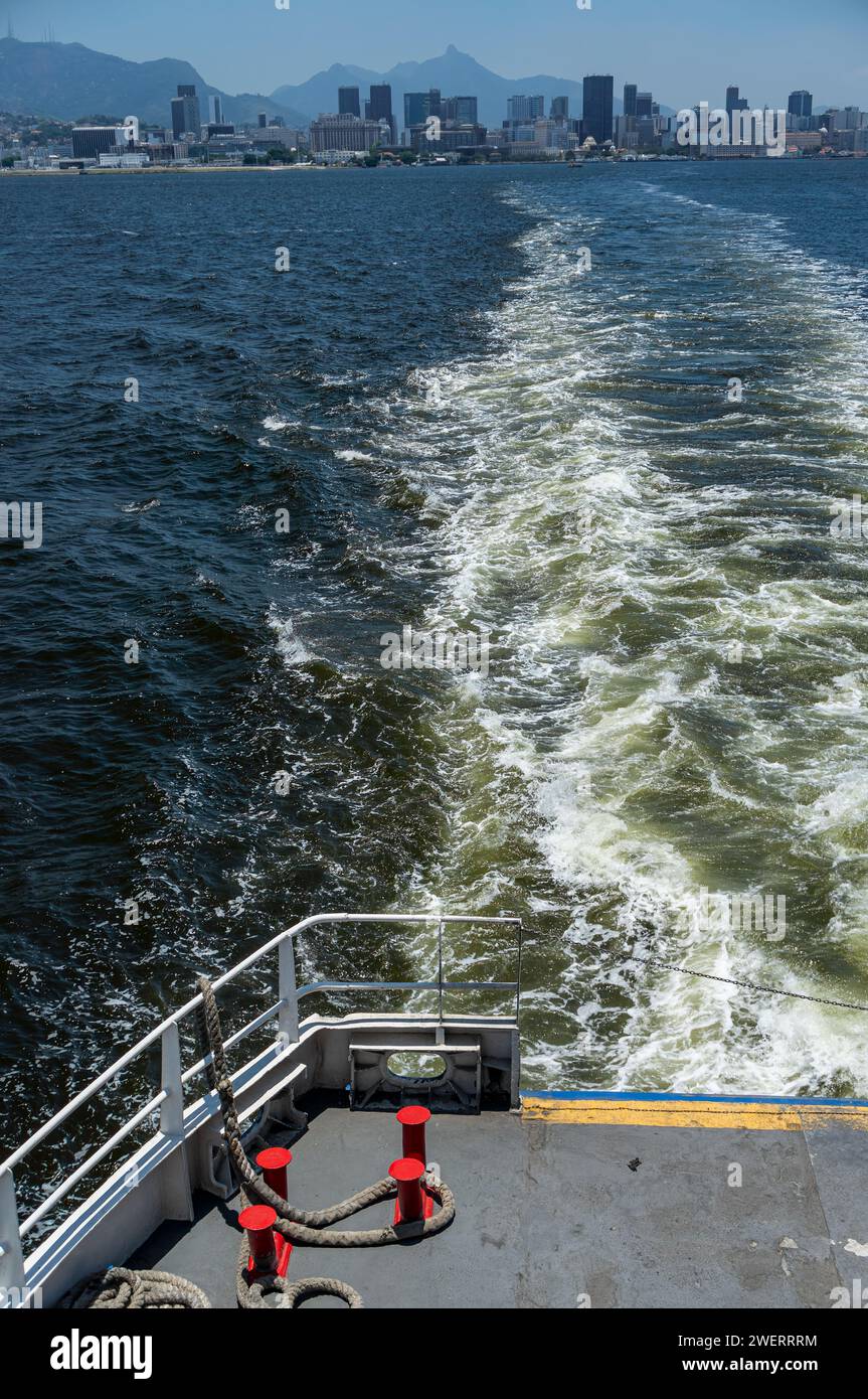 A passenger ferry watercraft boat making a big water wake on Guanabara ...