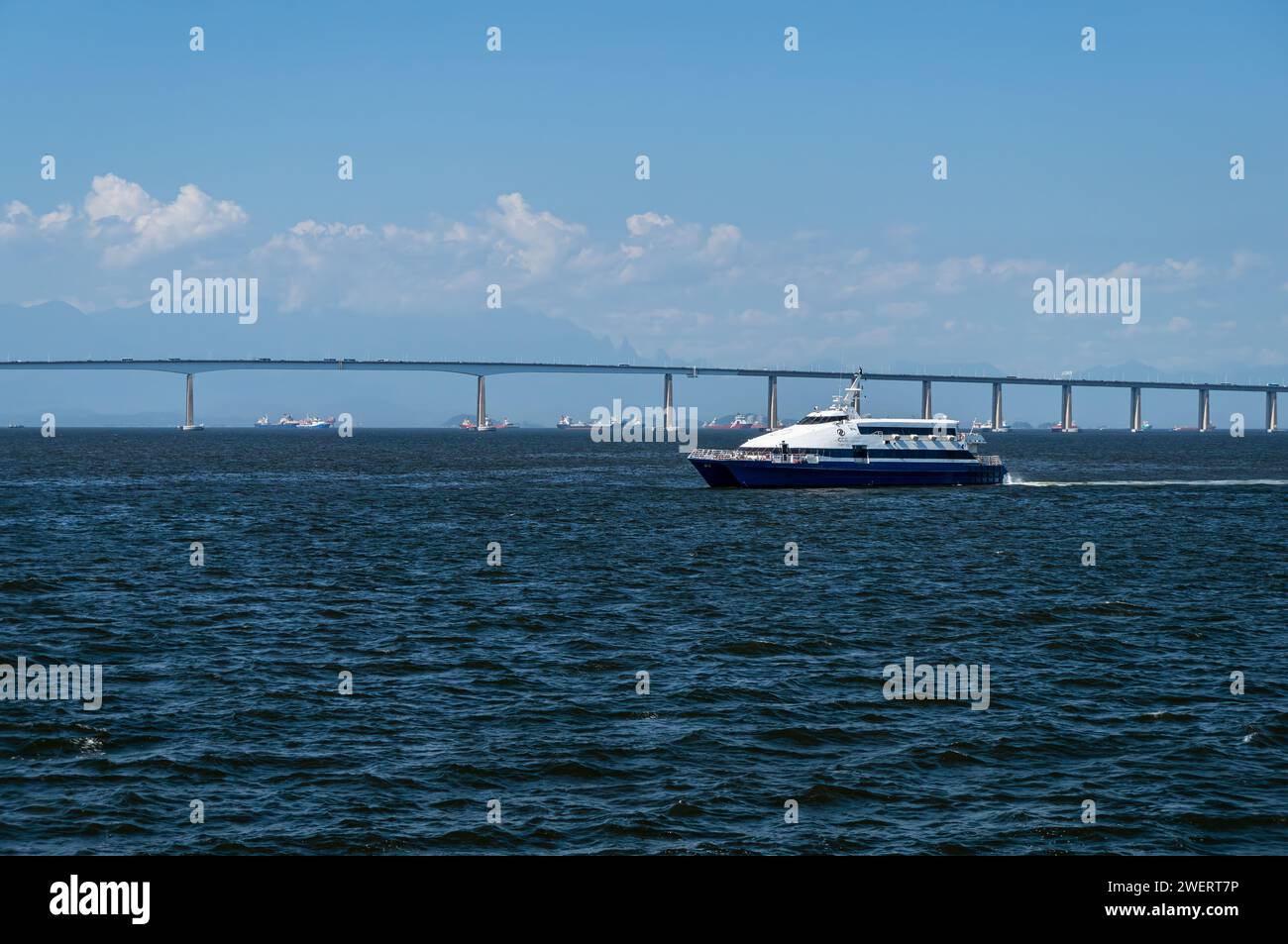 A small ferry boat sailing on Guanabara bay blue waters heading Rio's ...