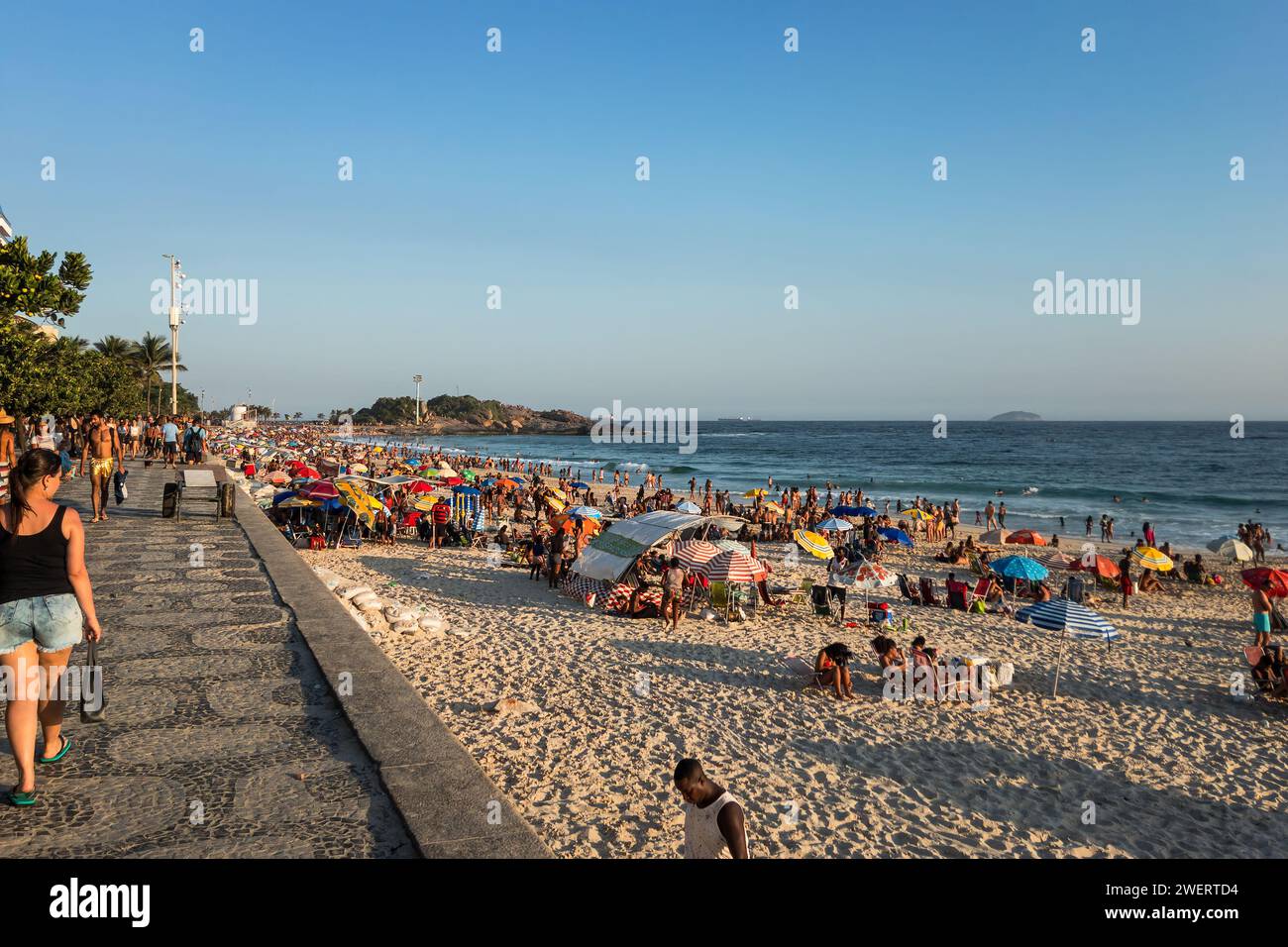 Wide shot of the heavily crowded Arpoador beach east end with Arpoador ...
