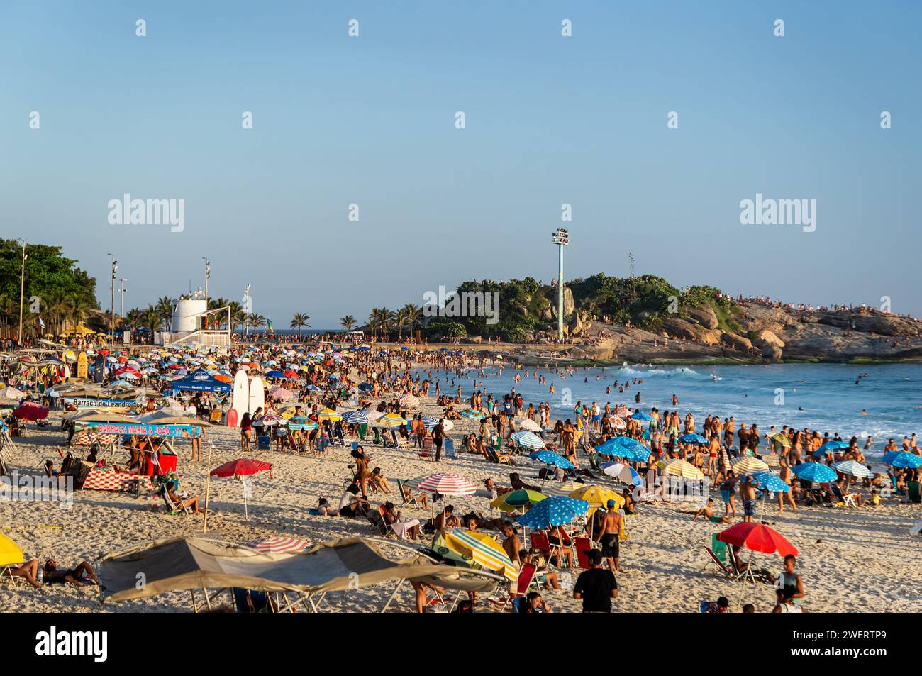 A completely crowded Arpoador beach shoreline with Arpoador Rock (Pedra ...