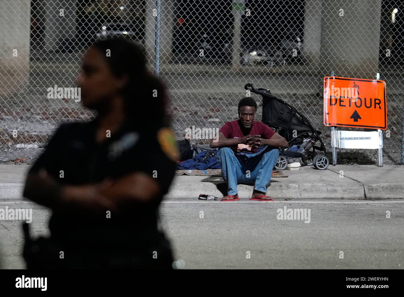 An unsheltered person looks toward City of Miami Police Officer Shareka ...