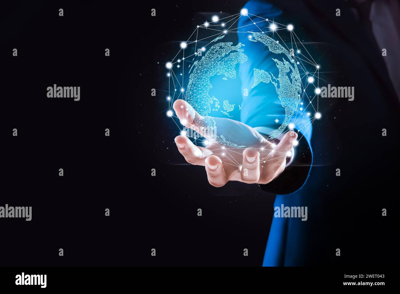 Global innovation. Businessman holding virtual planet on black ...