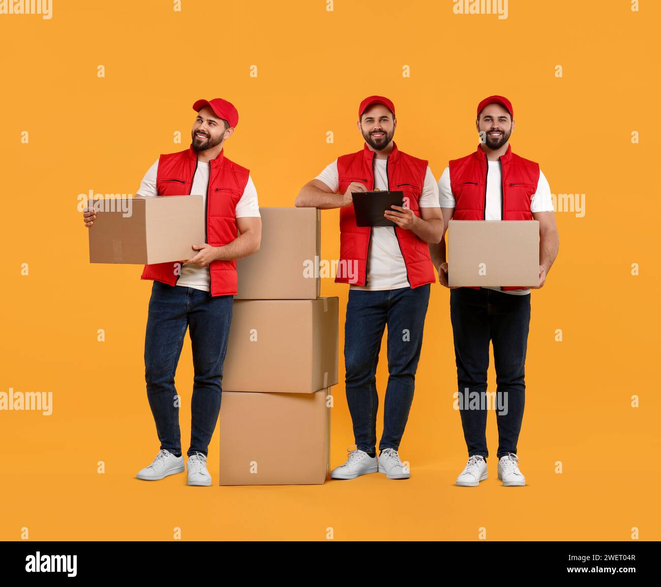 Delivery service. Happy courier with cardboard boxes on orange ...