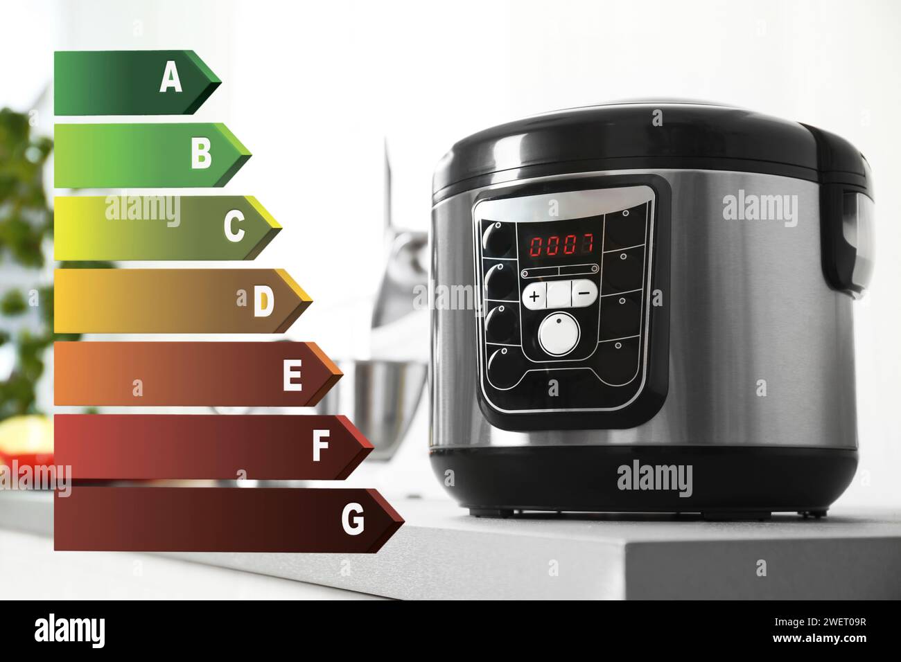 Energy efficiency rating label and multi cooker on table indoors Stock ...