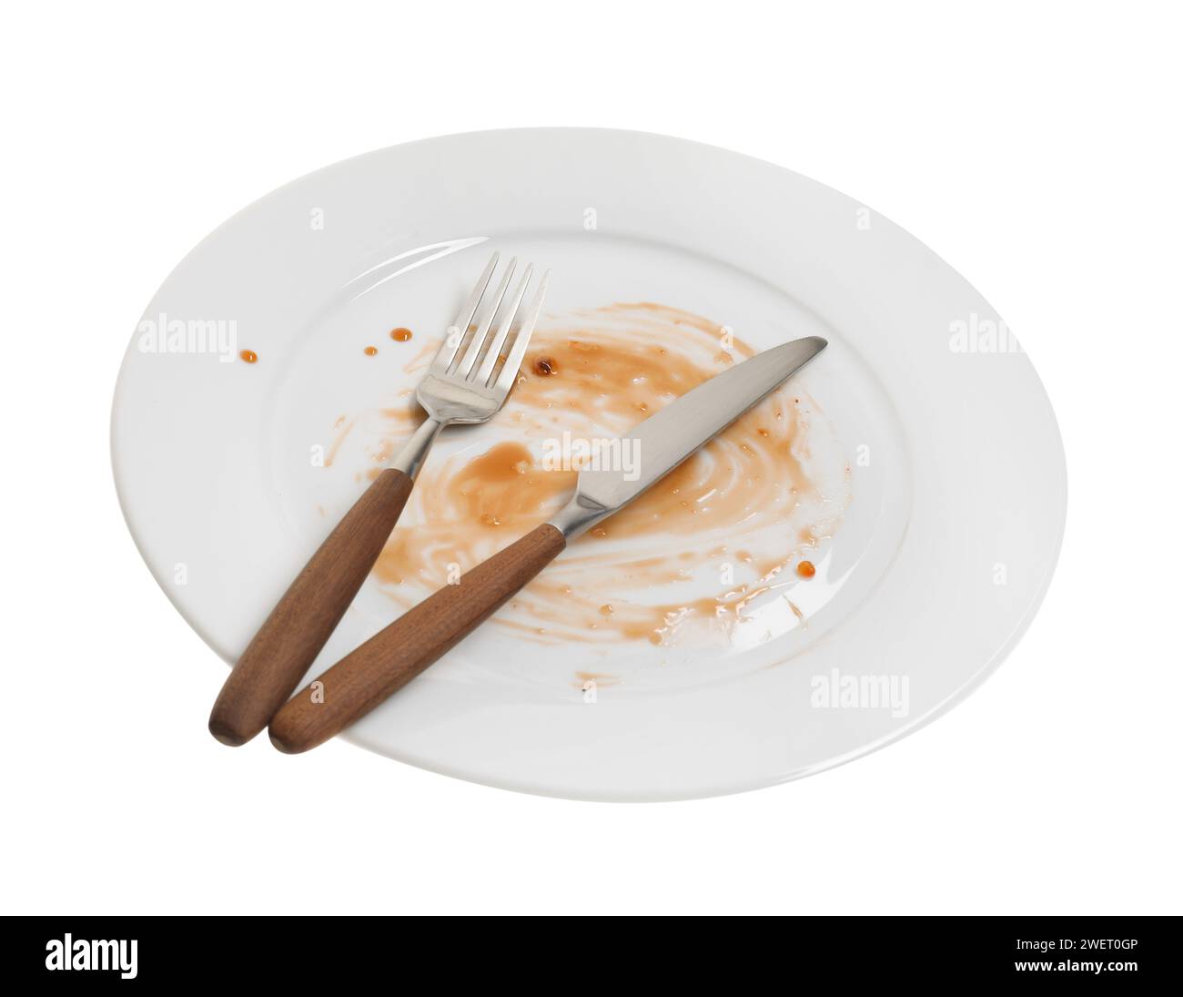 Dirty plate and cutlery on white background Stock Photo - Alamy