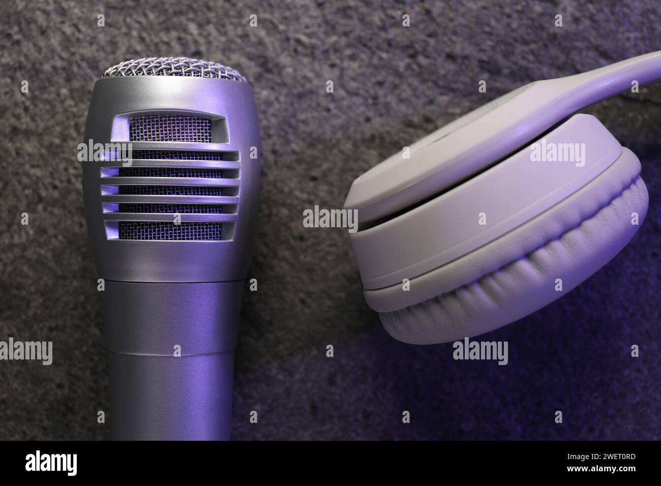Microphone and headphones on grey textured background, flat lay. Sound ...