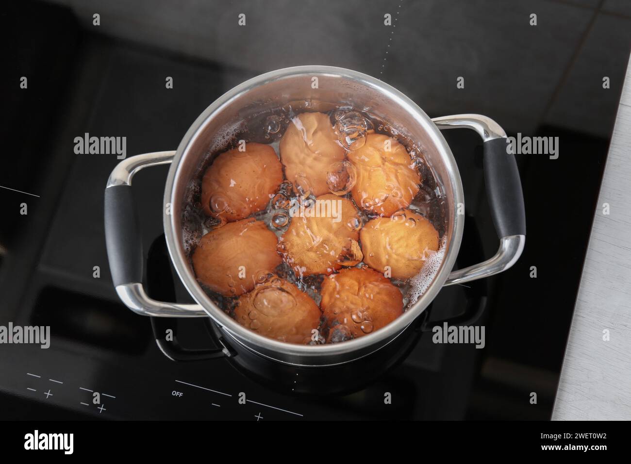 Chicken eggs boiling in pot on electric stove, top view Stock Photo - Alamy