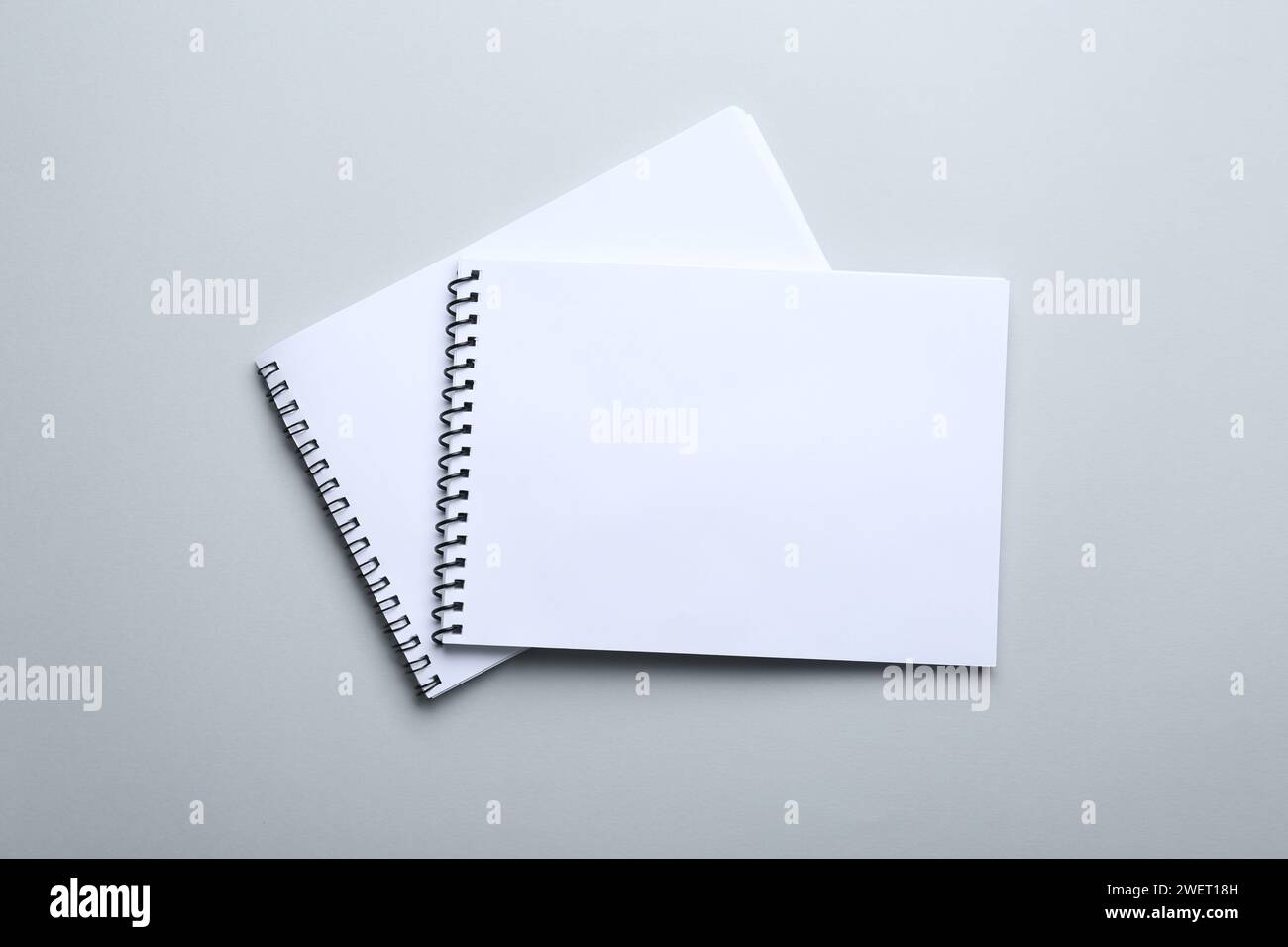 Notebooks on light grey background, top view. Space for text Stock ...