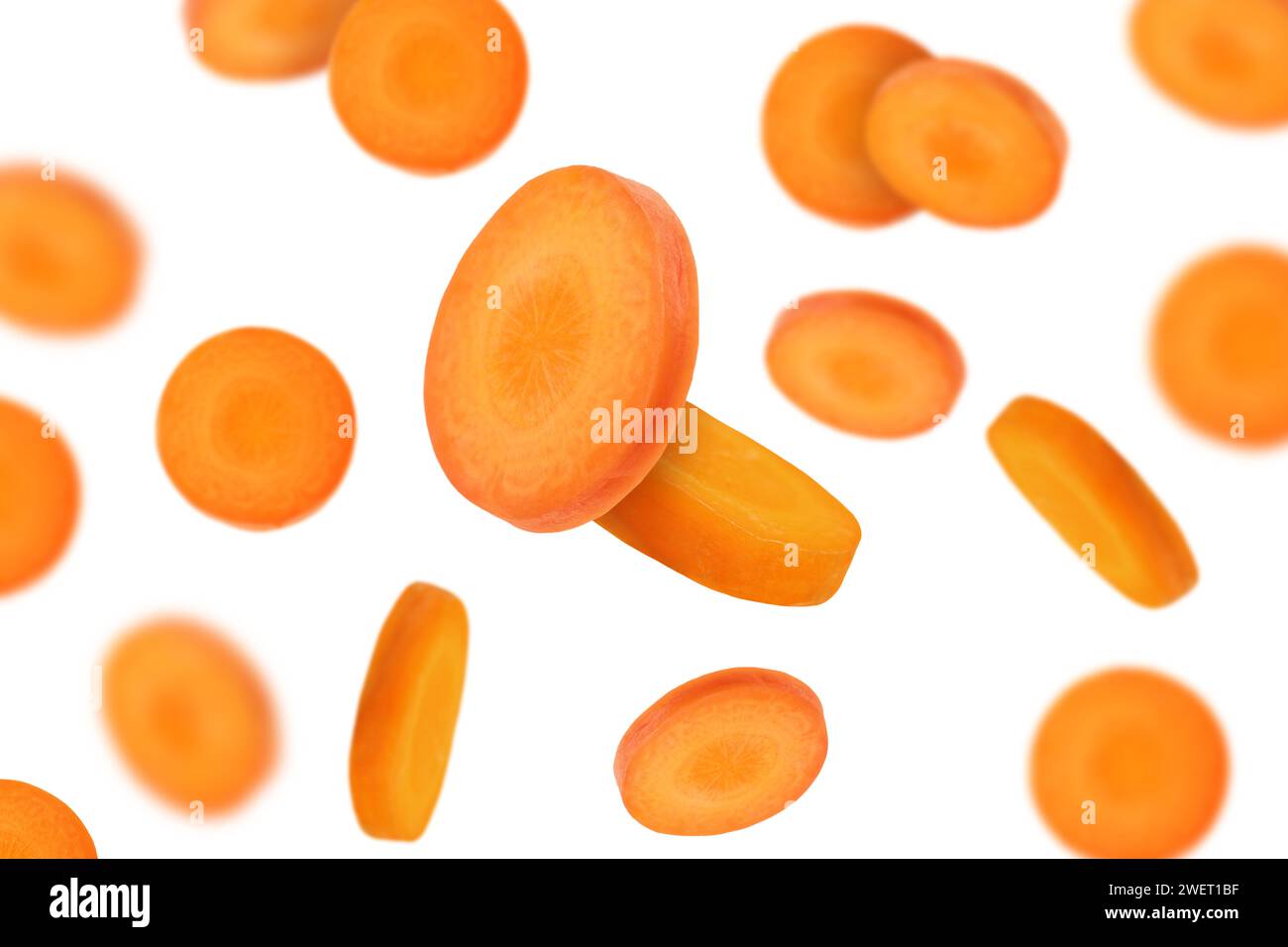Fresh carrot slices falling on white background Stock Photo - Alamy