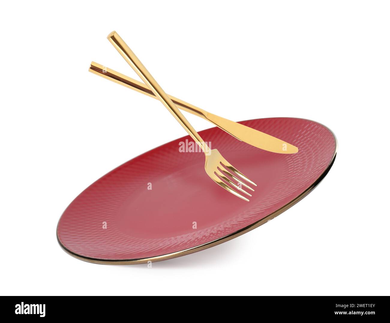 Clean plate, fork and knife falling on white background Stock Photo - Alamy
