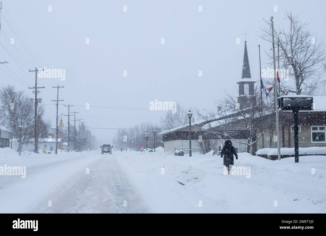 Fort Smith, Canada. 26th Jan, 2024. A pedestrian walks along the main ...