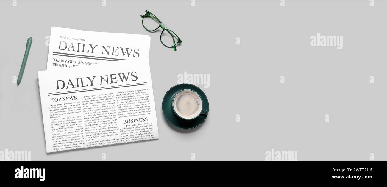 Daily newspapers with eyeglasses, cup of coffee and pen on grey ...