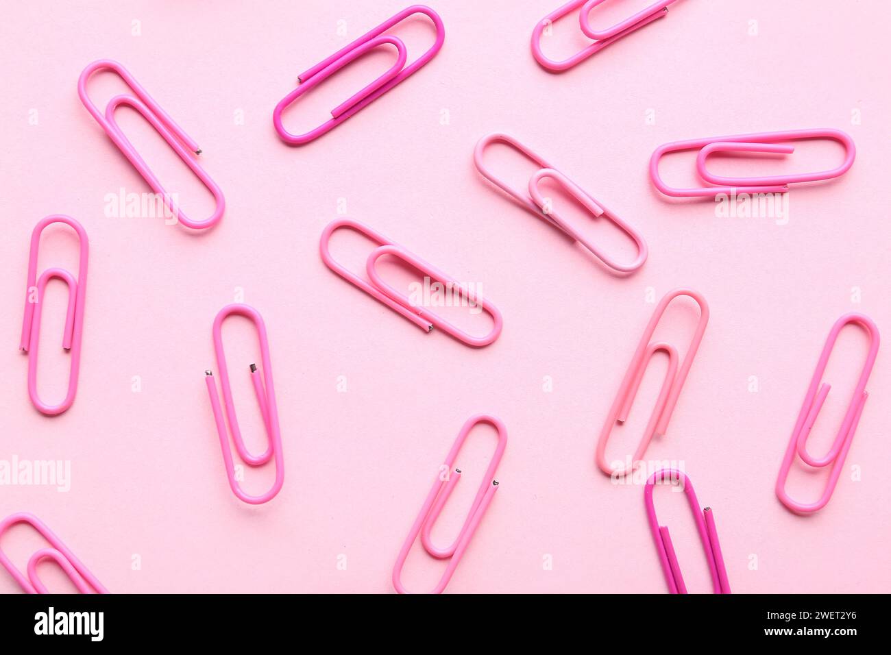 Set of paperclips on pink background Stock Photo - Alamy