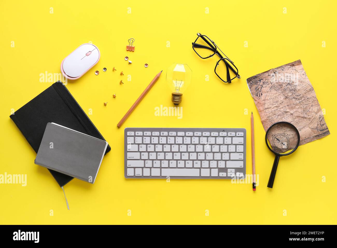 Composition with modern computer keyboard, mouse, magnifier, world map ...