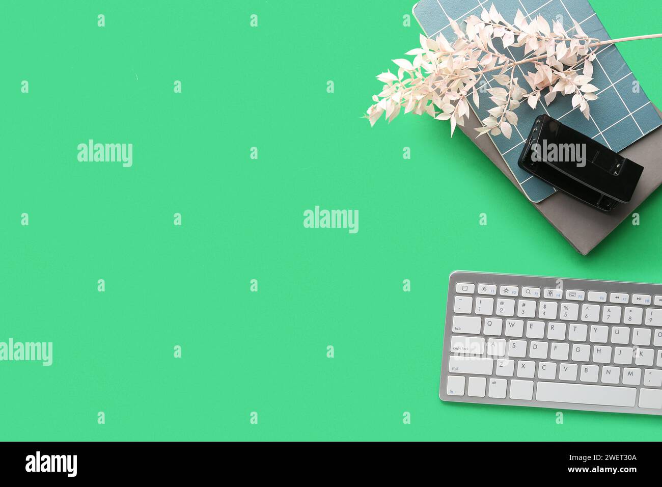 Composition with modern computer keyboard, notebooks and stapler on ...