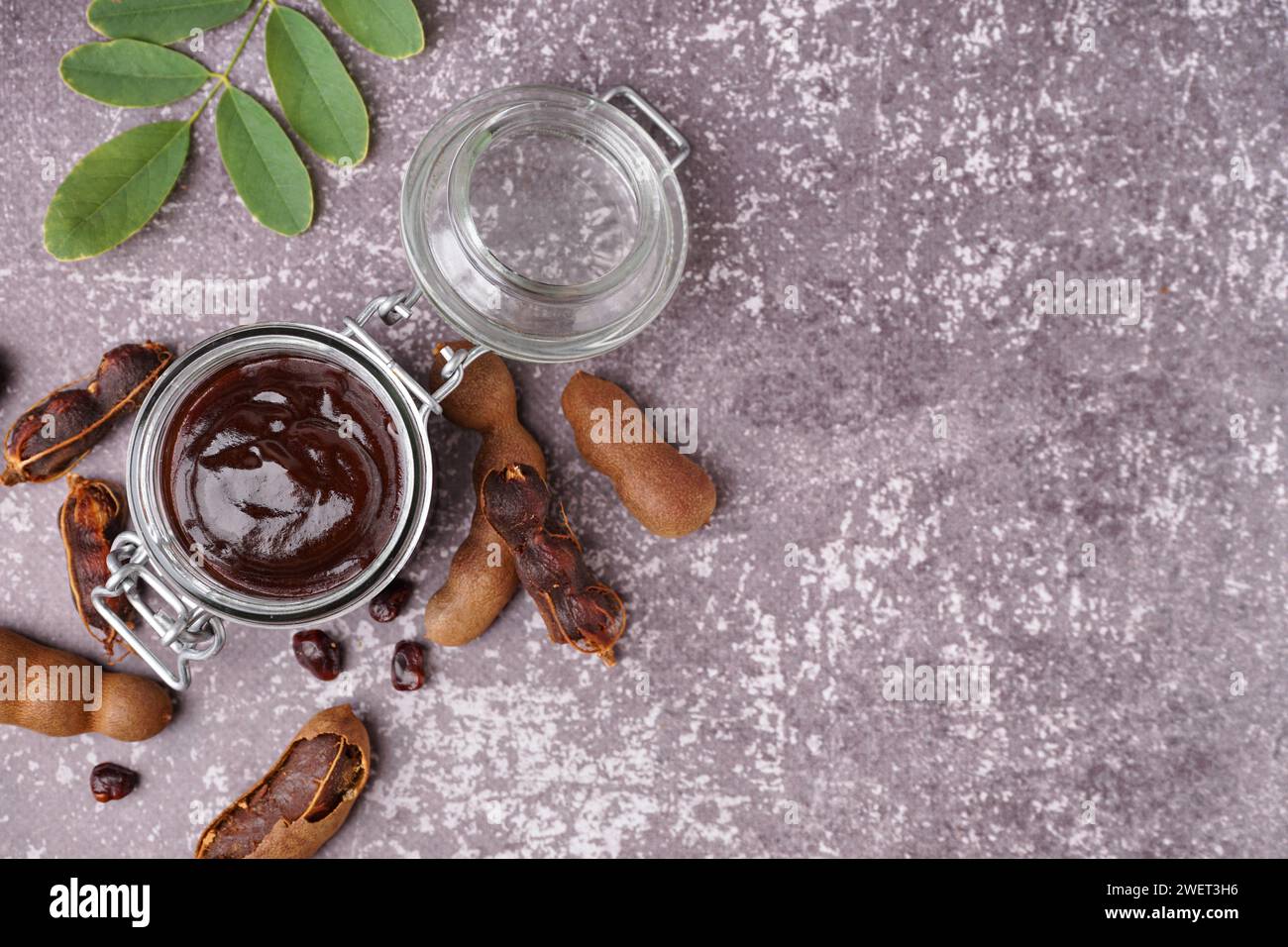 Jar with tasty tamarind jam and fruits on grey background Stock Photo ...