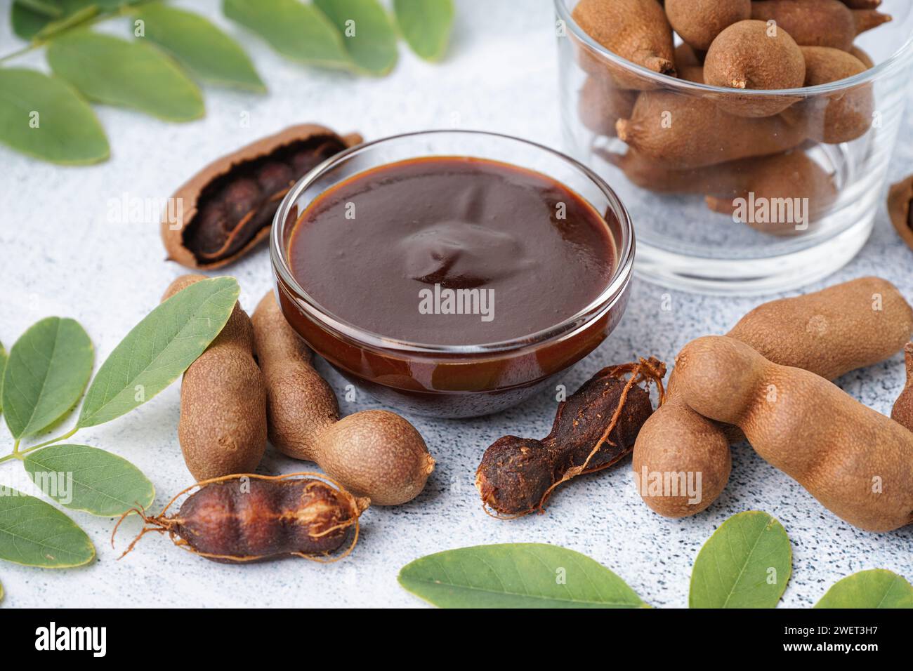 Bowl with tasty tamarind jam and fruits on white background Stock Photo ...