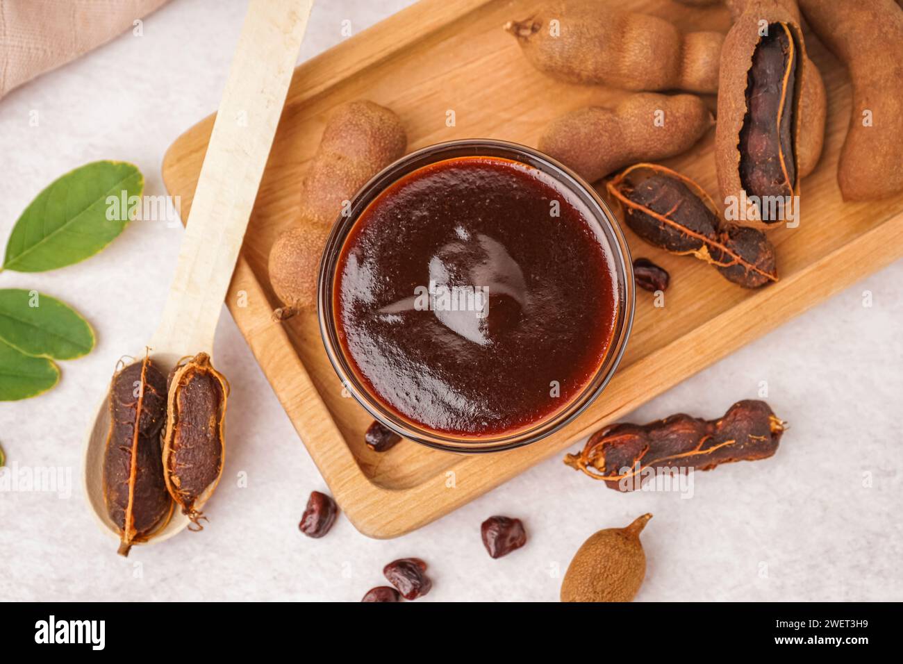 Bowl with tasty tamarind jam and fruits on white background Stock Photo ...
